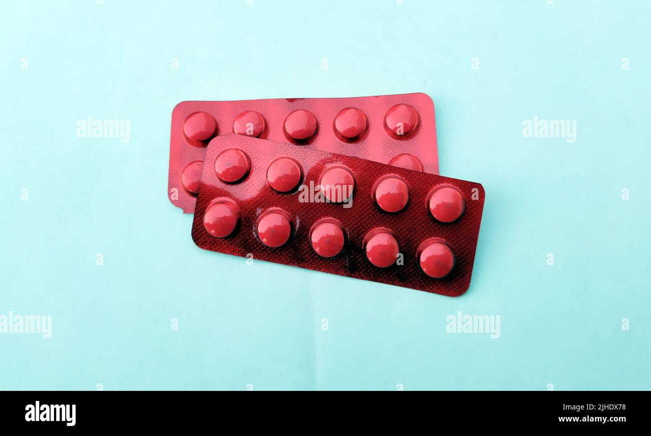 medecine red tablets isolated on white backgroun Stock Photo - Alamy