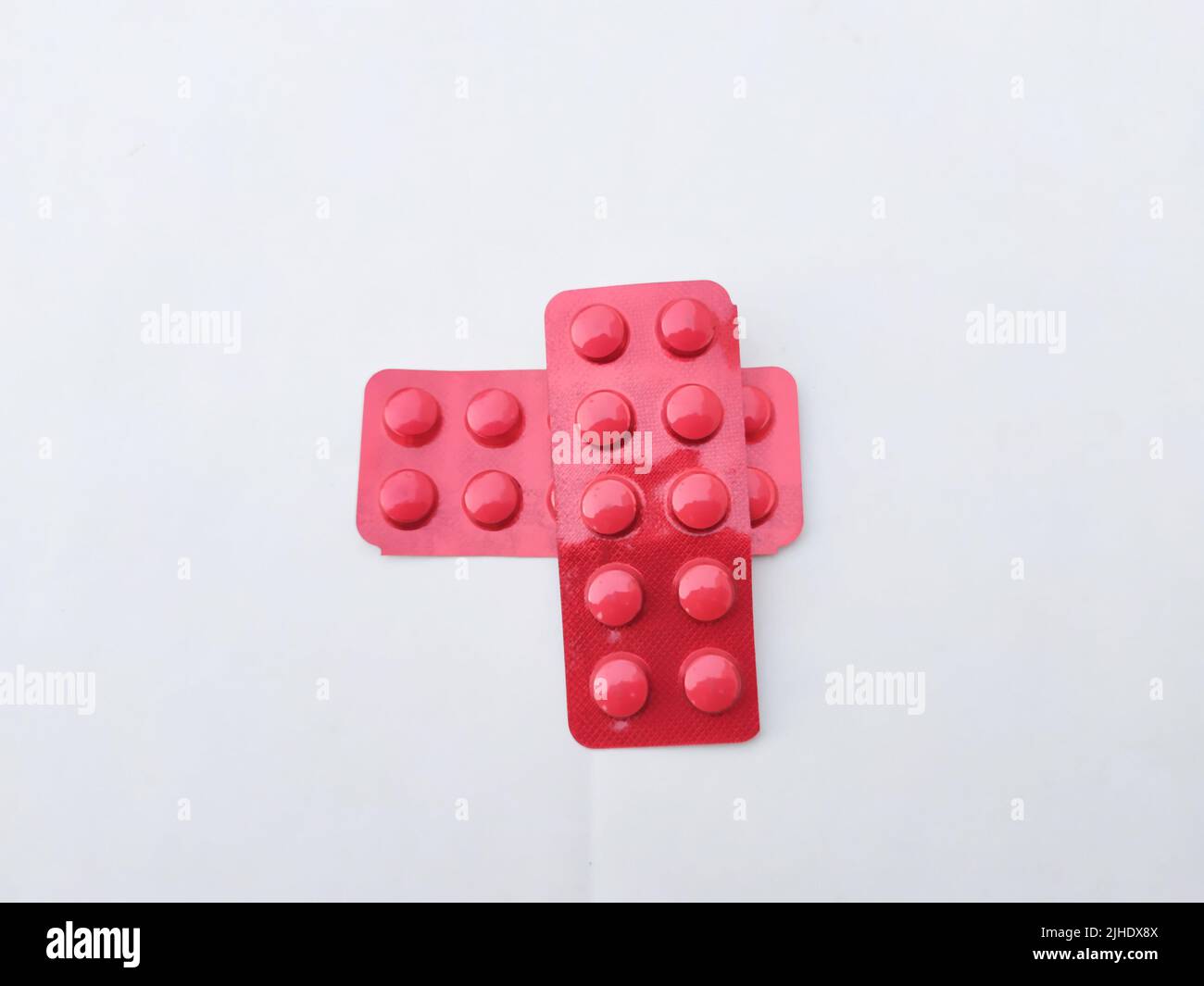 medecine red tablets isolated on white backgroun Stock Photo - Alamy
