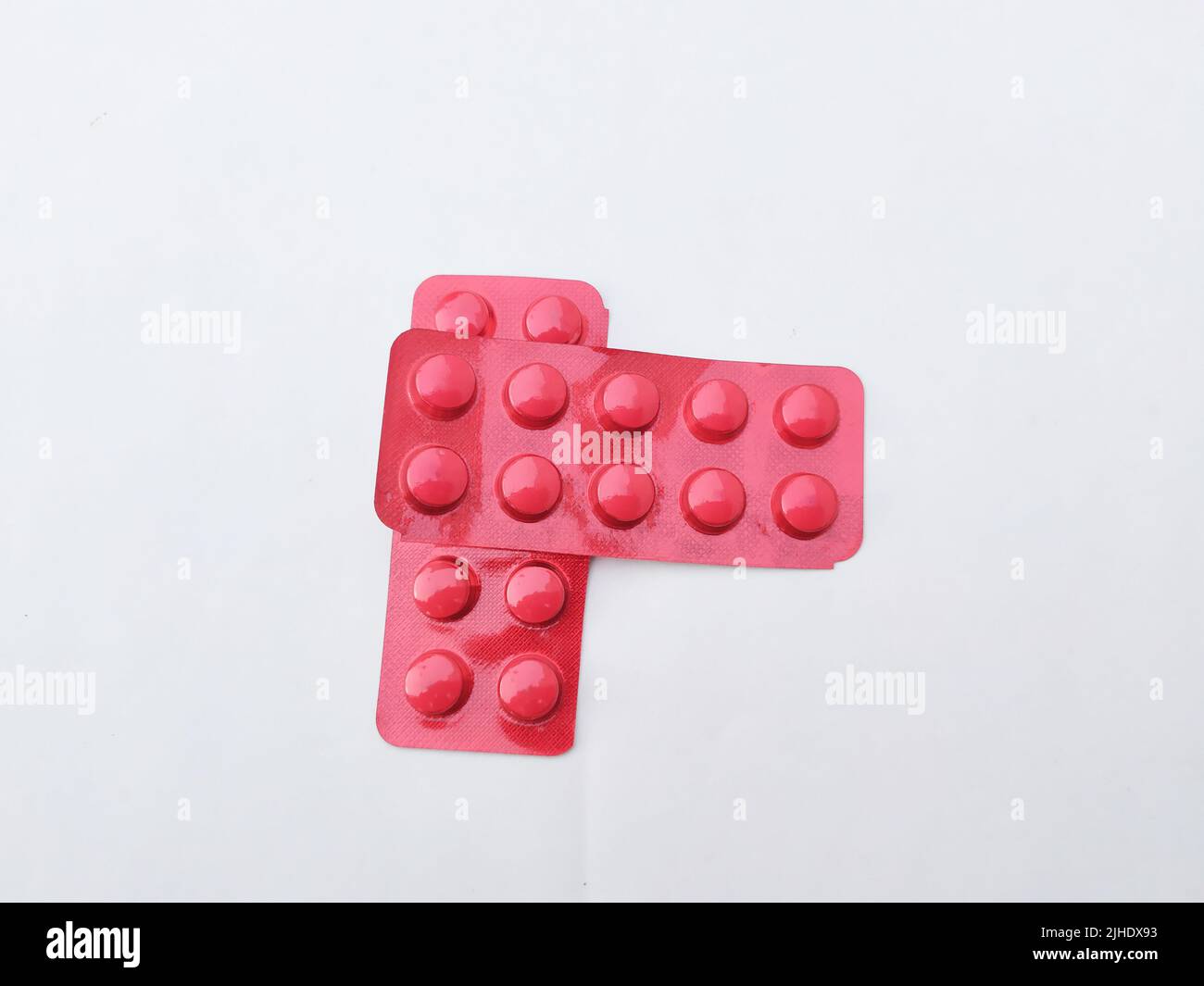 medecine red tablets isolated on white backgroun Stock Photo - Alamy