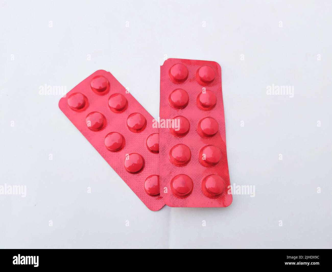 medecine red tablets isolated on white backgroun Stock Photo - Alamy