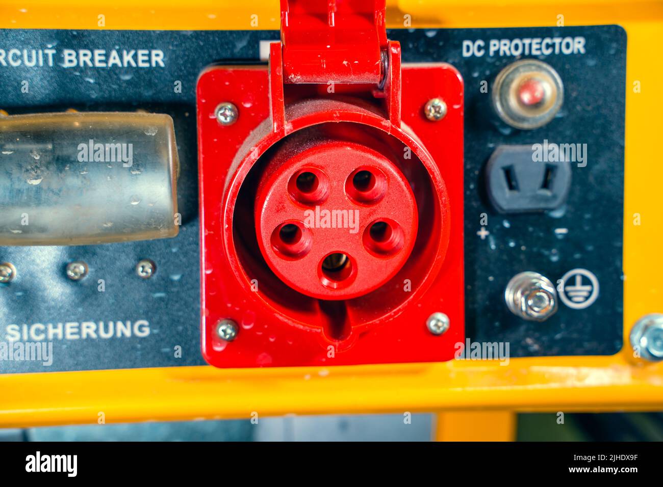 Industrial red power socket with earth close-up. Gasoline generator ...