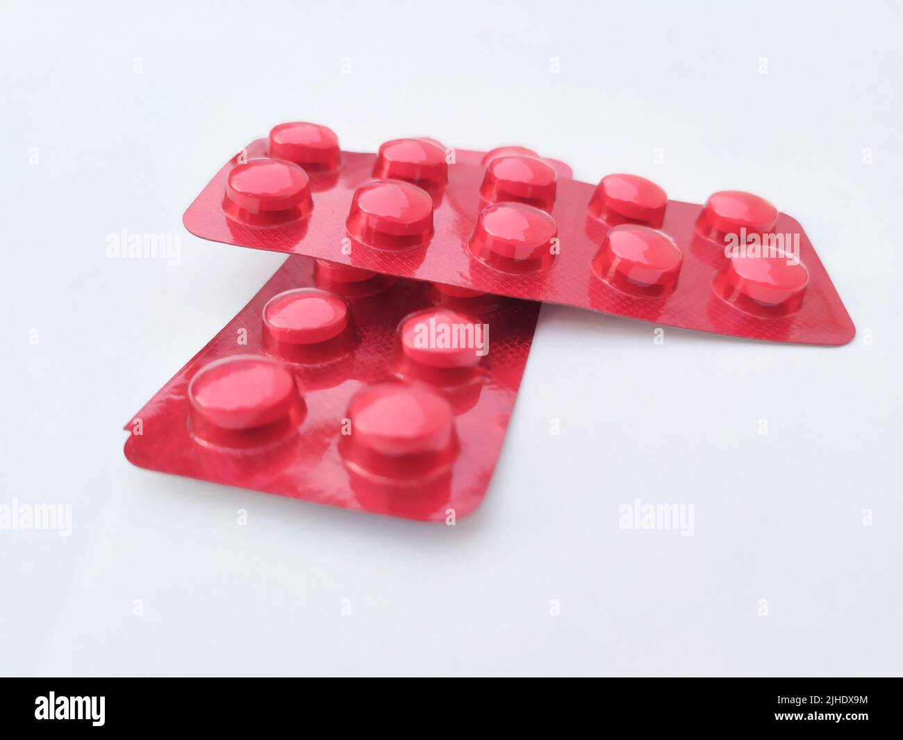 medecine red tablets isolated on white backgroun Stock Photo - Alamy