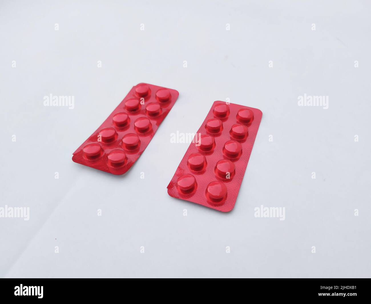 medecine red tablets isolated on white backgroun Stock Photo - Alamy
