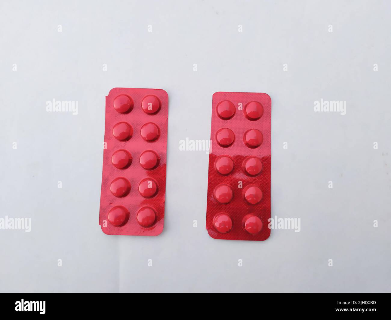 medecine red tablets isolated on white backgroun Stock Photo - Alamy