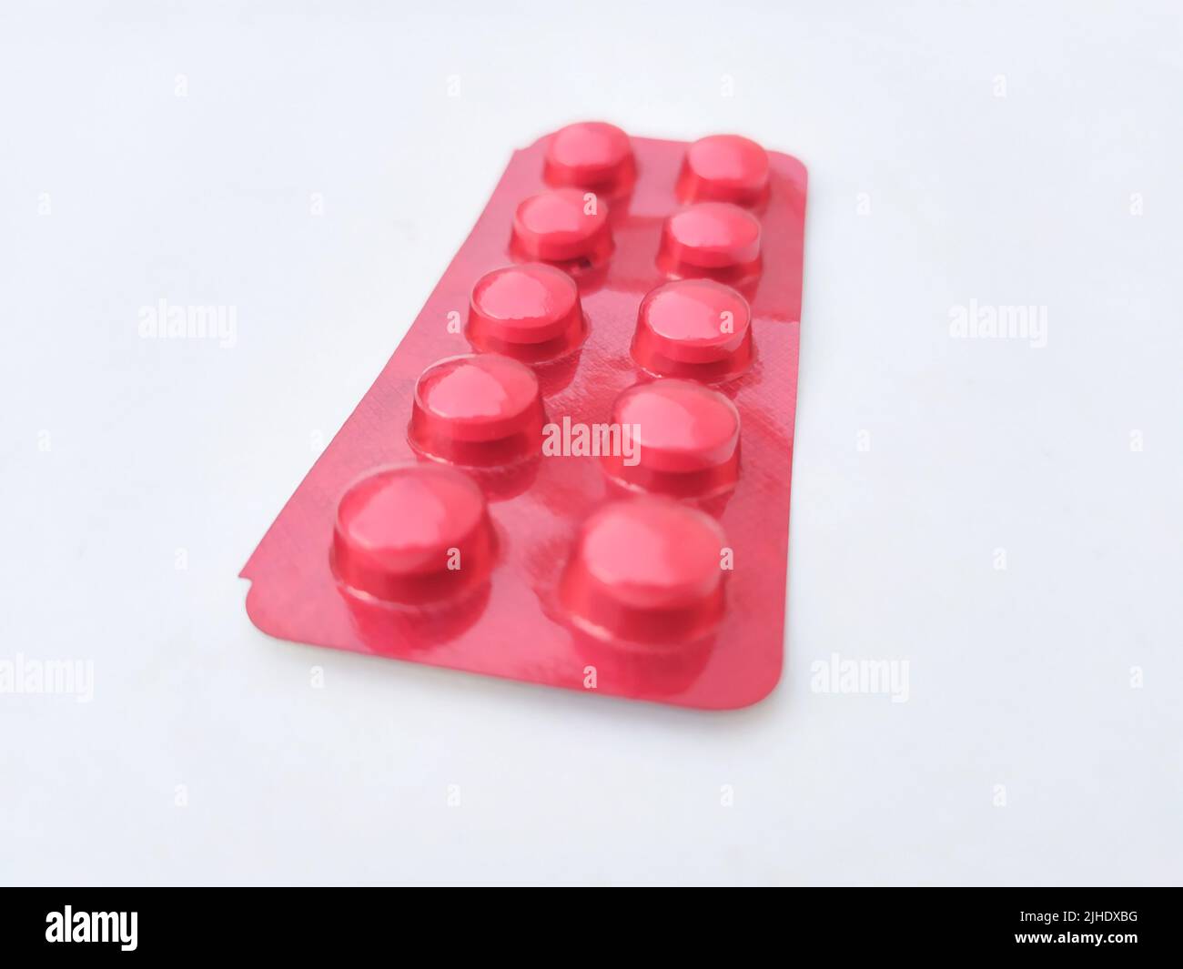 medecine red tablets isolated on white backgroun Stock Photo - Alamy