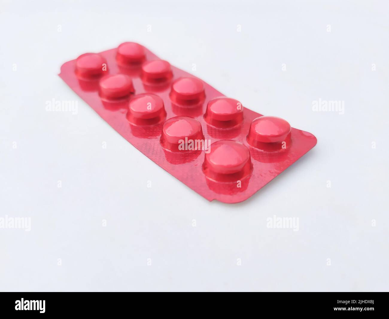 medecine red tablets isolated on white backgroun Stock Photo - Alamy