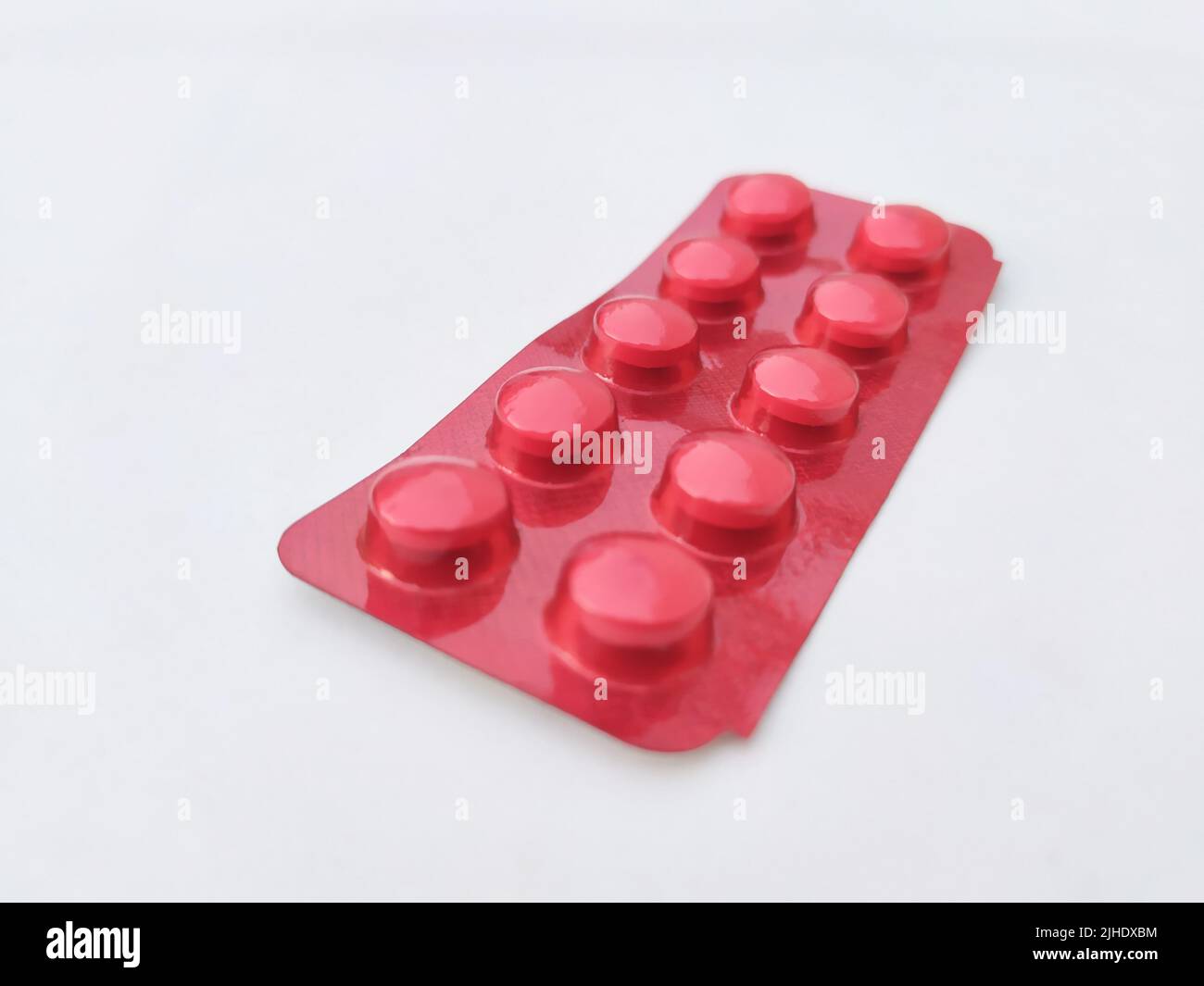 medecine red tablets isolated on white backgroun Stock Photo - Alamy
