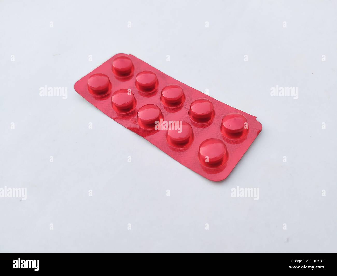 medecine red tablets isolated on white backgroun Stock Photo - Alamy