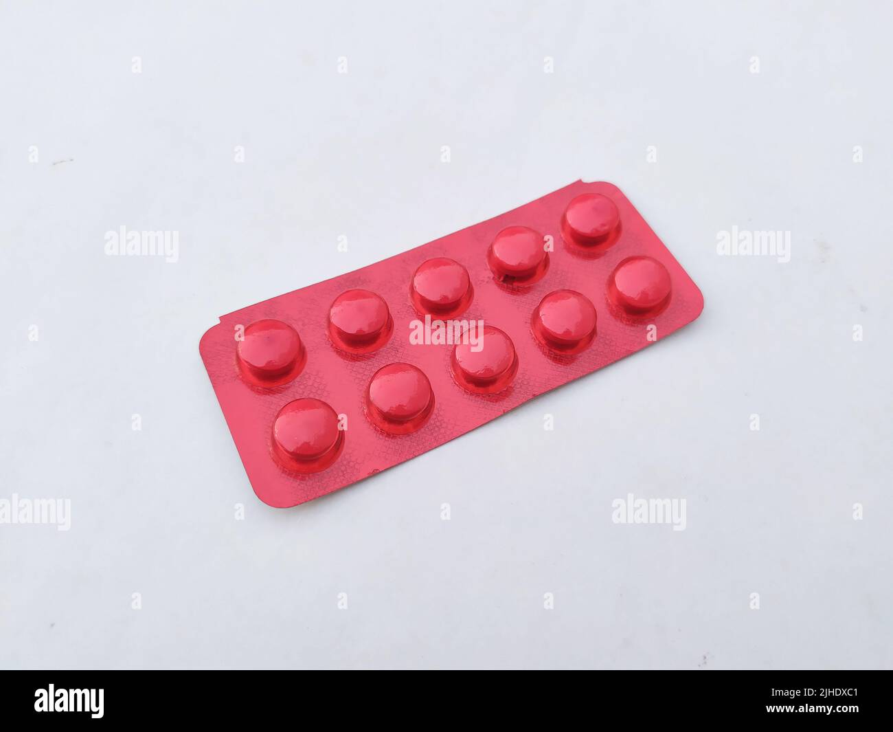 medecine red tablets isolated on white backgroun Stock Photo - Alamy