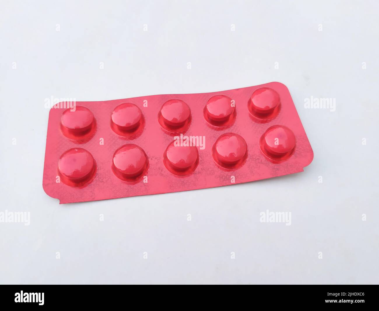 medecine red tablets isolated on white backgroun Stock Photo - Alamy