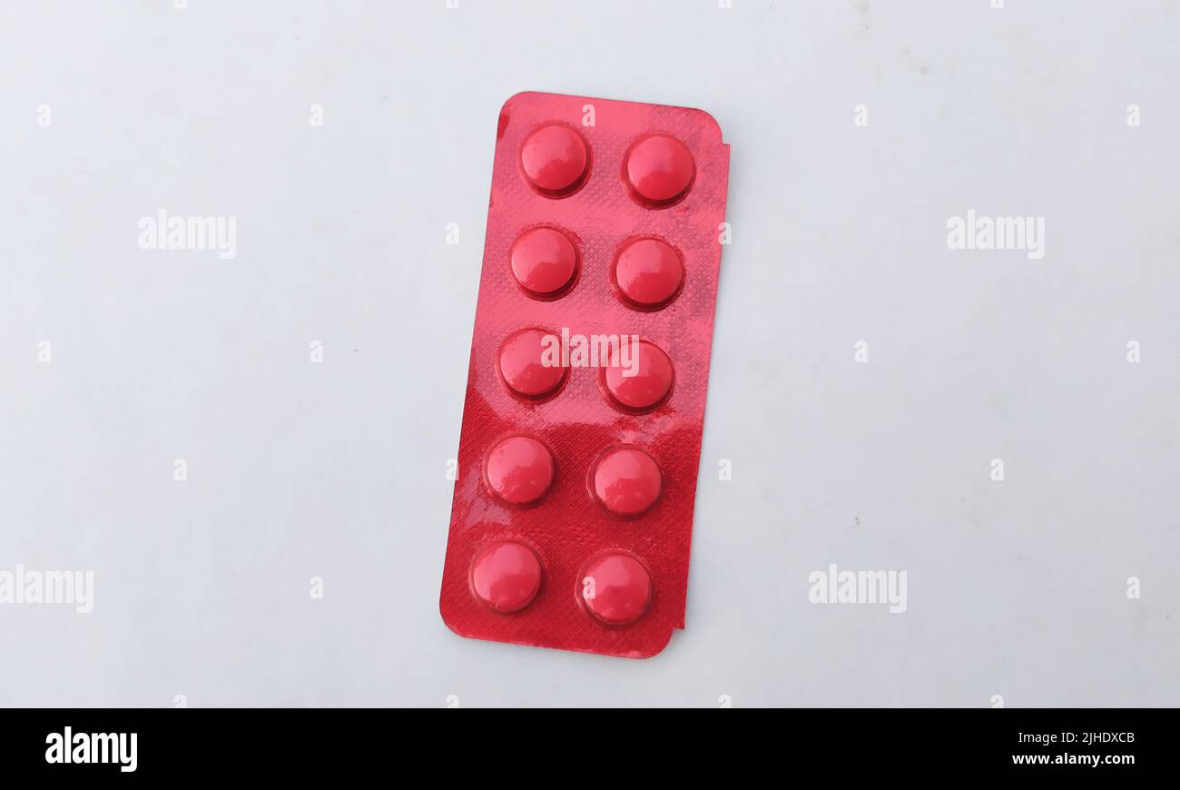 medecine red tablets isolated on white backgroun Stock Photo - Alamy