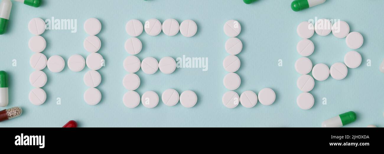 Help lettering made with white round pills, pharmaceutical medicament ...