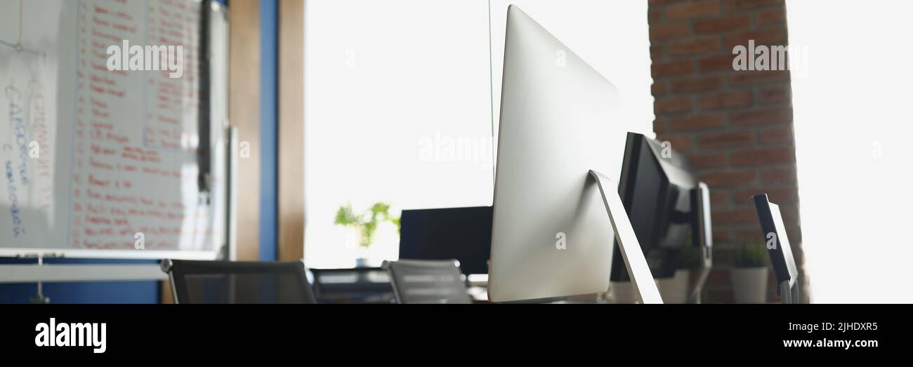 Empty office, computers on desks, light room for company employees ...