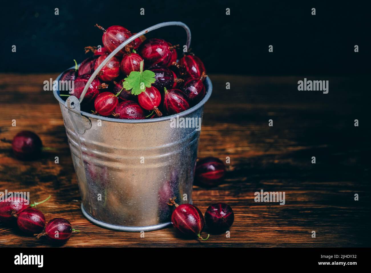 Full bucket gooseberry berries standing wooden background Stock Photo ...