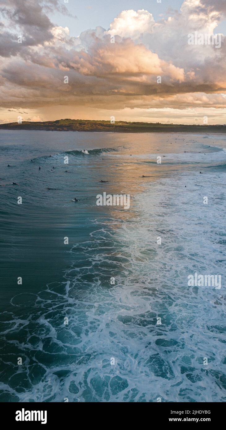 Beautiful golden sunset reflected on surface of the undulating ocean ...