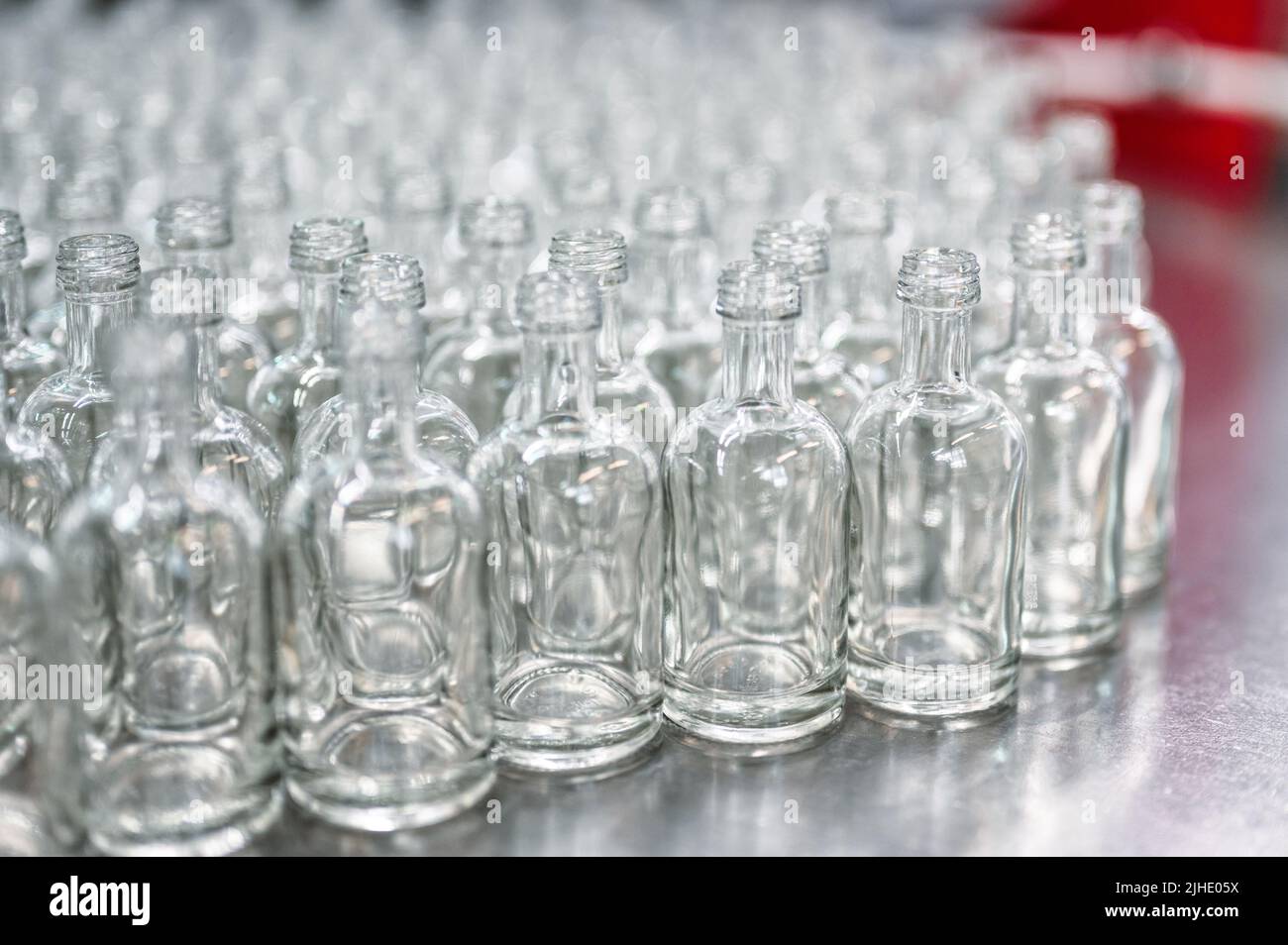Group of glass bottles for alcohol drink on metal table Stock Photo - Alamy