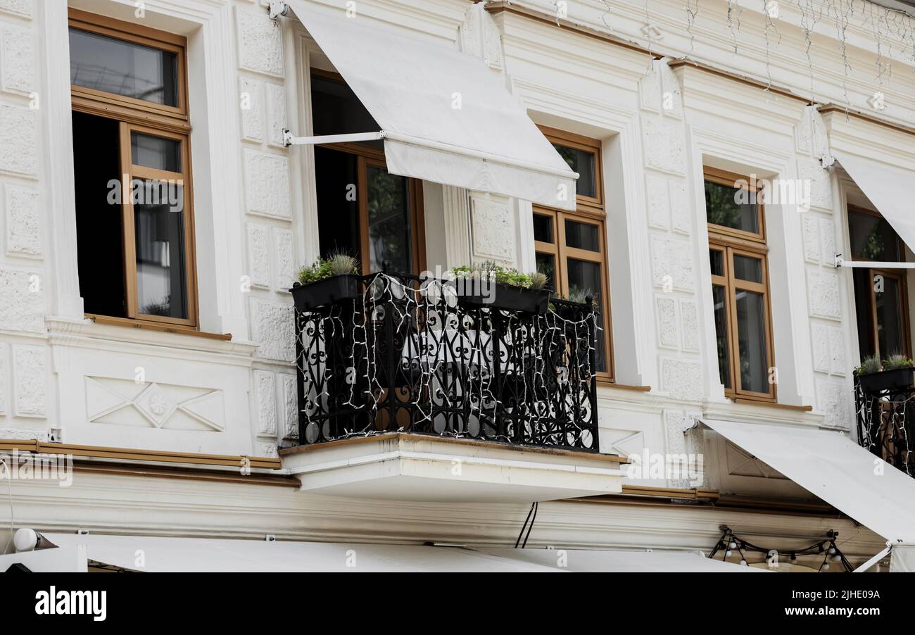 small cozy balcony with coffee table on the old European street Stock ...