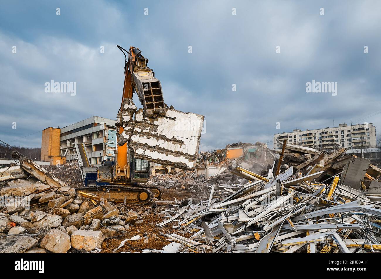 A construction excavator equipped with a hydraulic concrete breaker ...