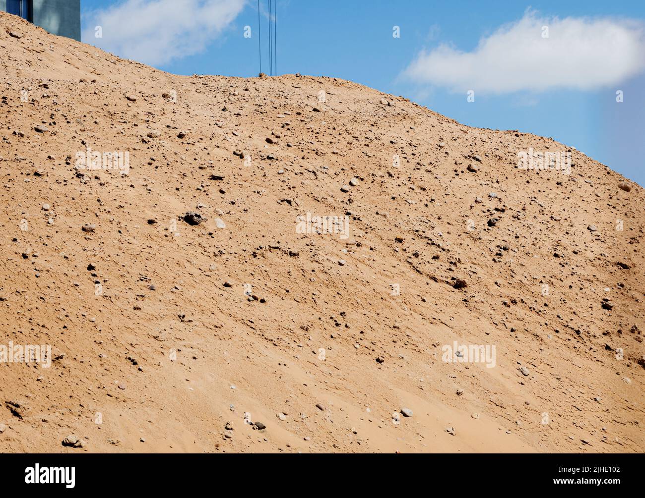 construction sand pile with blue sky Stock Photo - Alamy