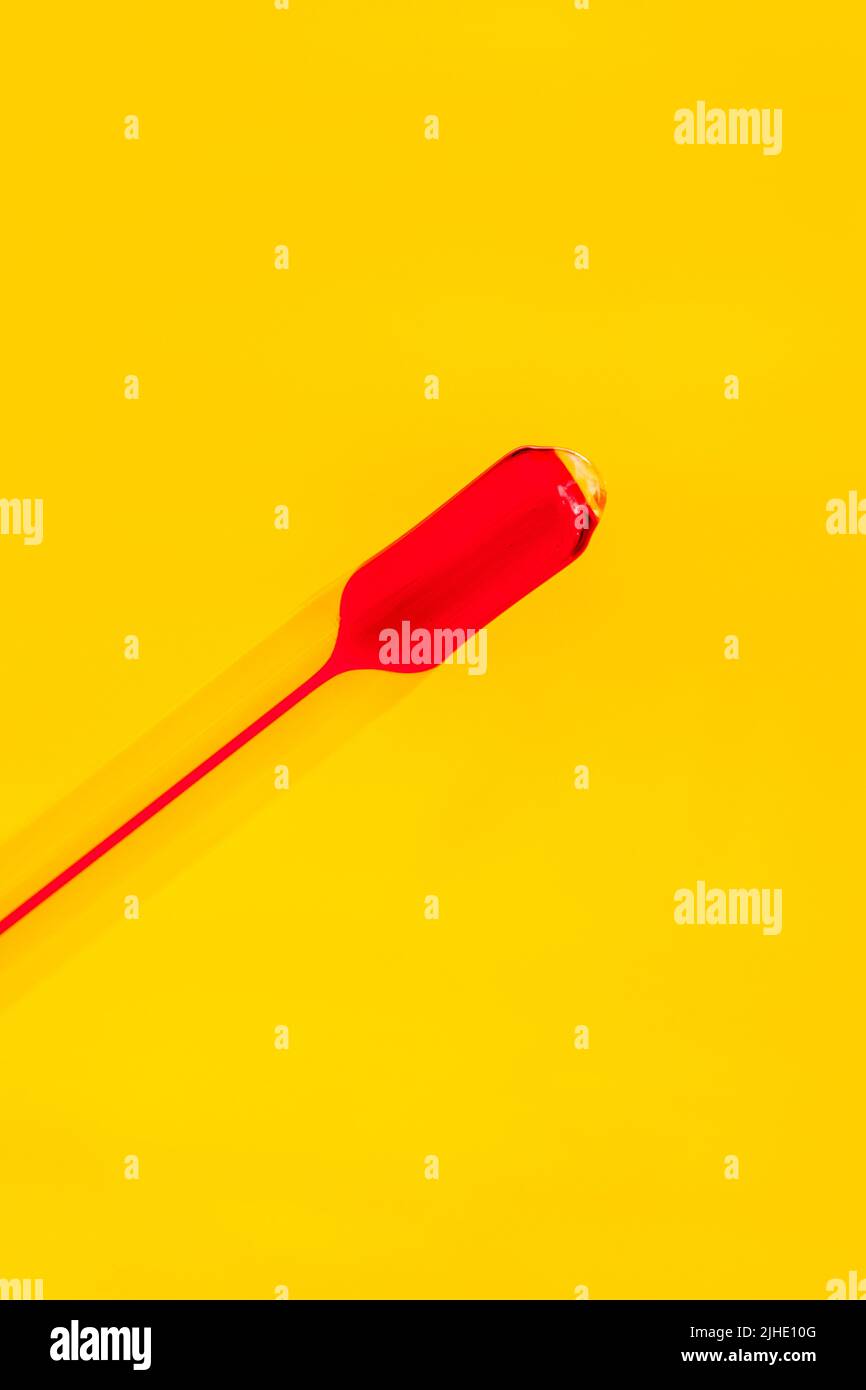 Glass red ink thermometer bulb on a colour background. For 202.32 ...