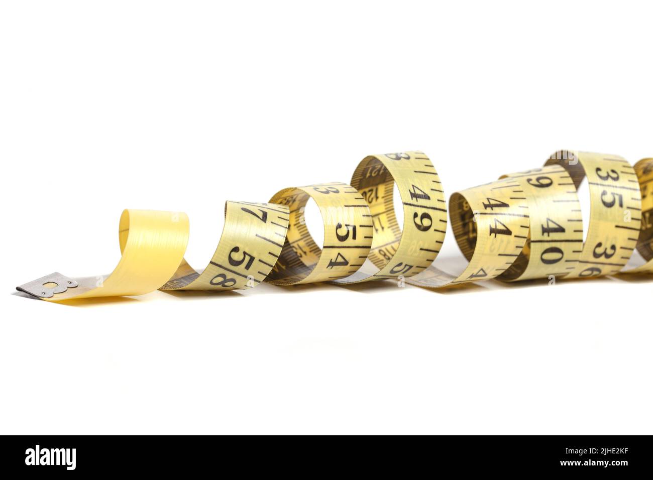Yellow measuring tape isolated on a white background Stock Photo - Alamy