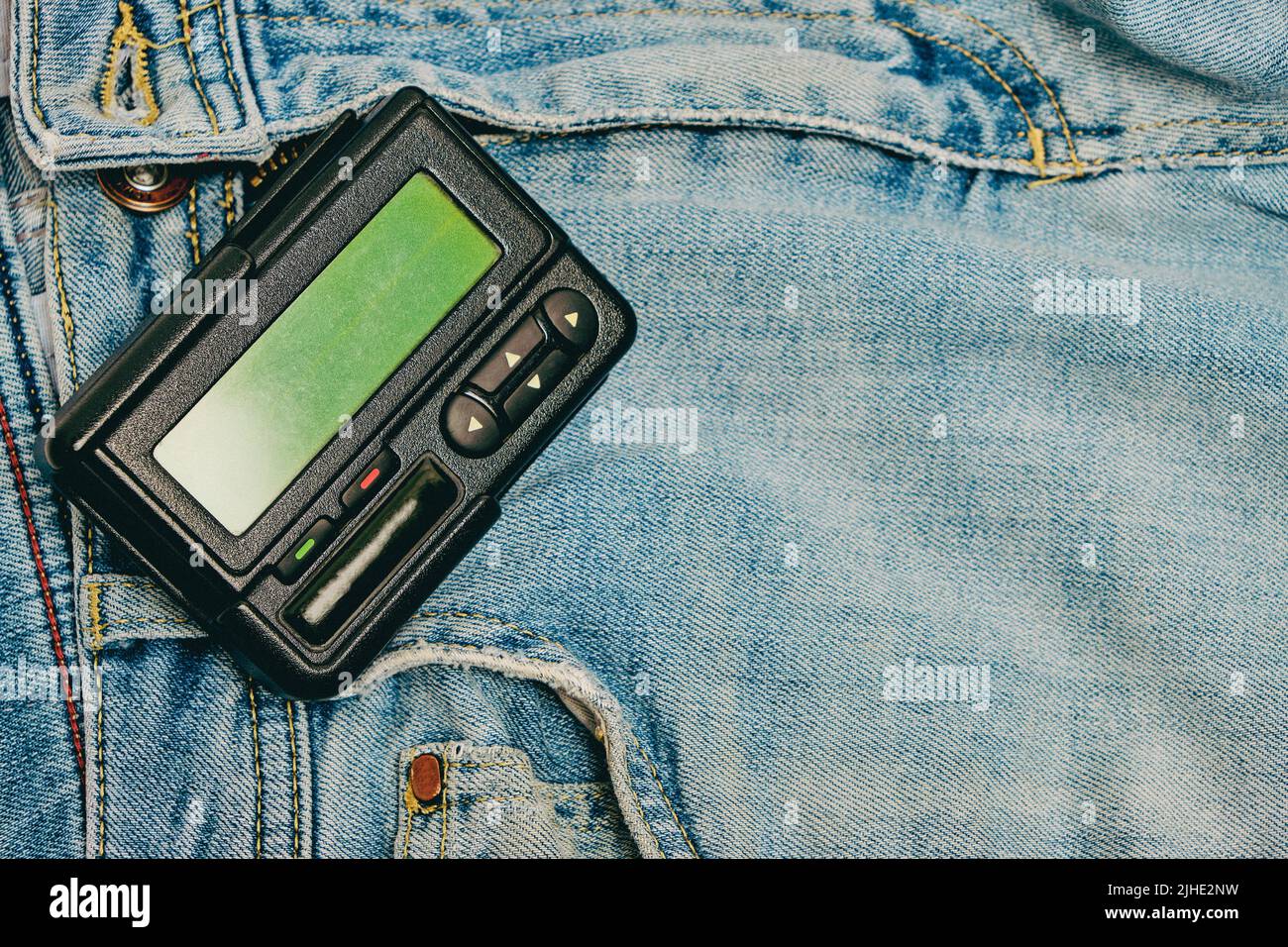 Pager is an old retro gadget for communication on jeans Stock Photo - Alamy