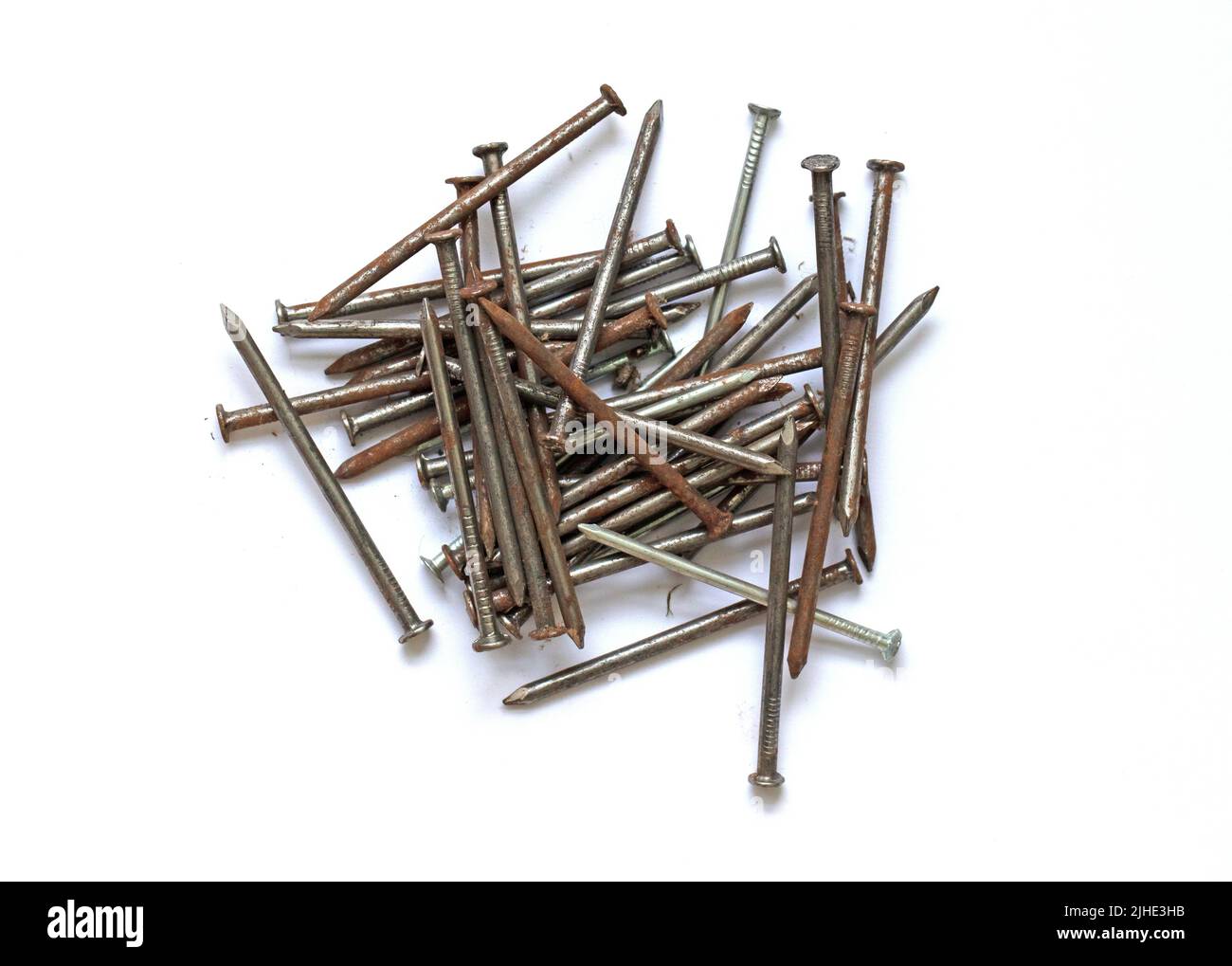 Large rusty nails on white background, isolated Stock Photo - Alamy