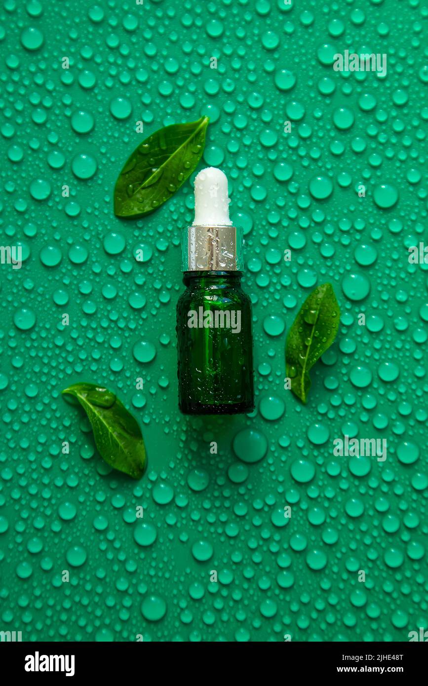 Bottle of cosmetics and drops of liquid, moisturizing. Hyaluronic acid. Selective focus. Spa ...