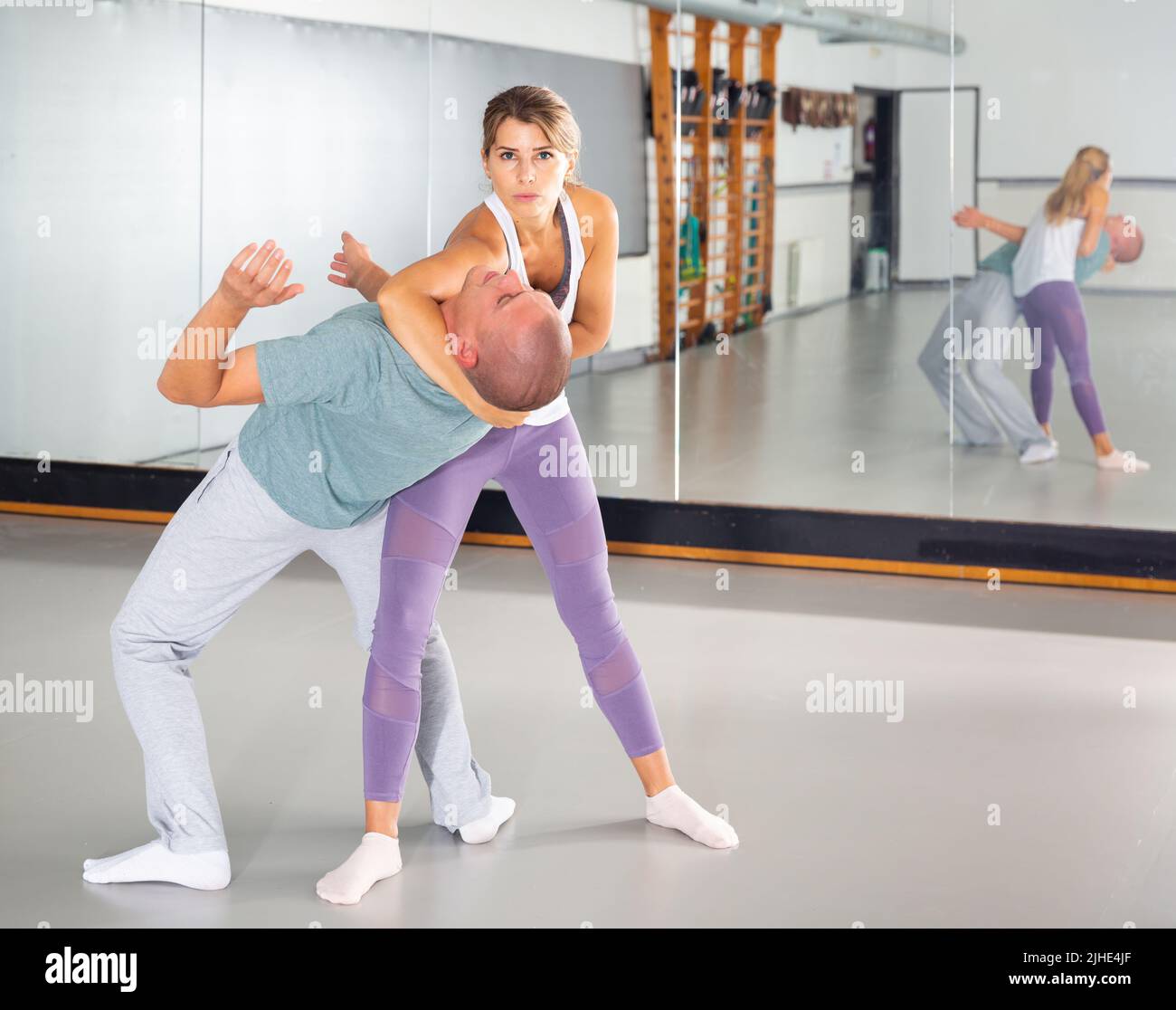 Woman practicing basic self defense movements with male partner Stock ...