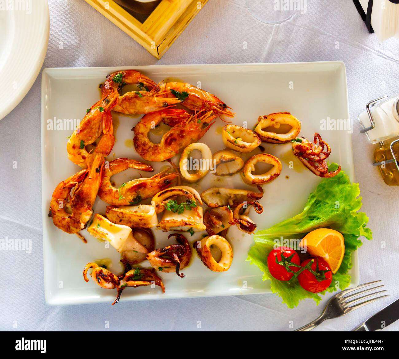 Fried shrimp, octopus and other seafood on plate Stock Photo - Alamy