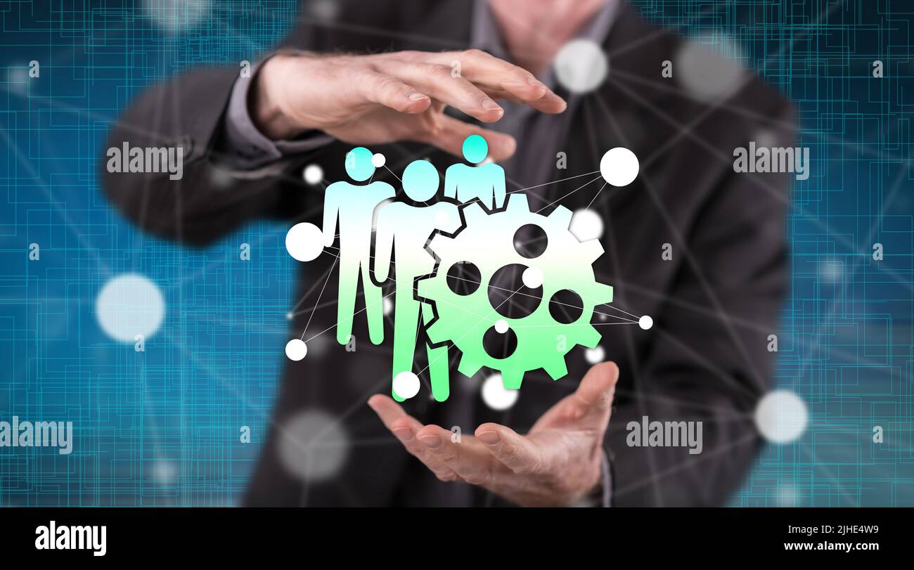 Hrm concept between hands of a man in background Stock Photo - Alamy