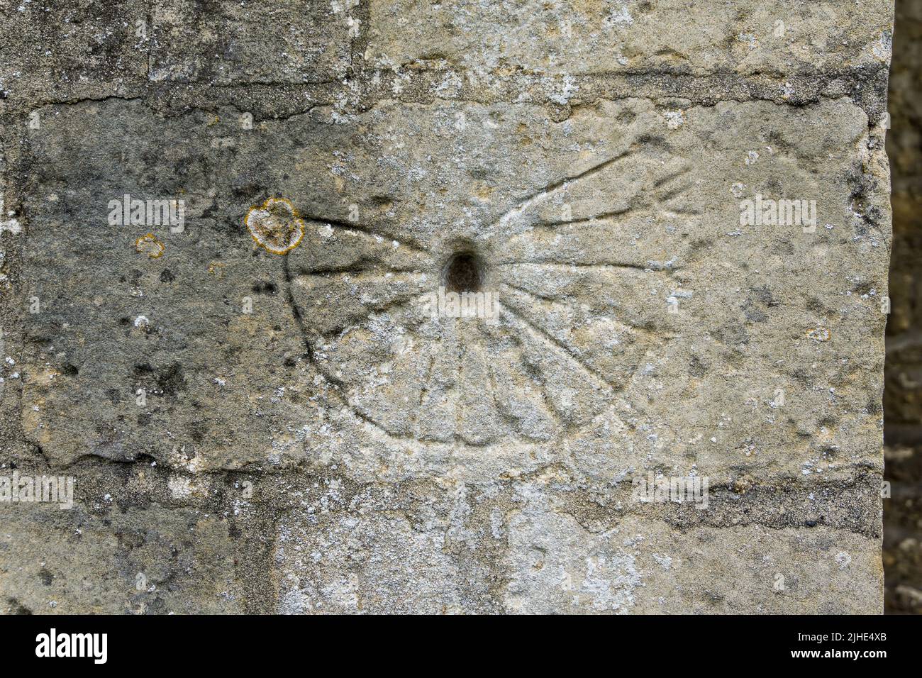 Medieval mass dial or scratch dial on the exterior of the church of St ...