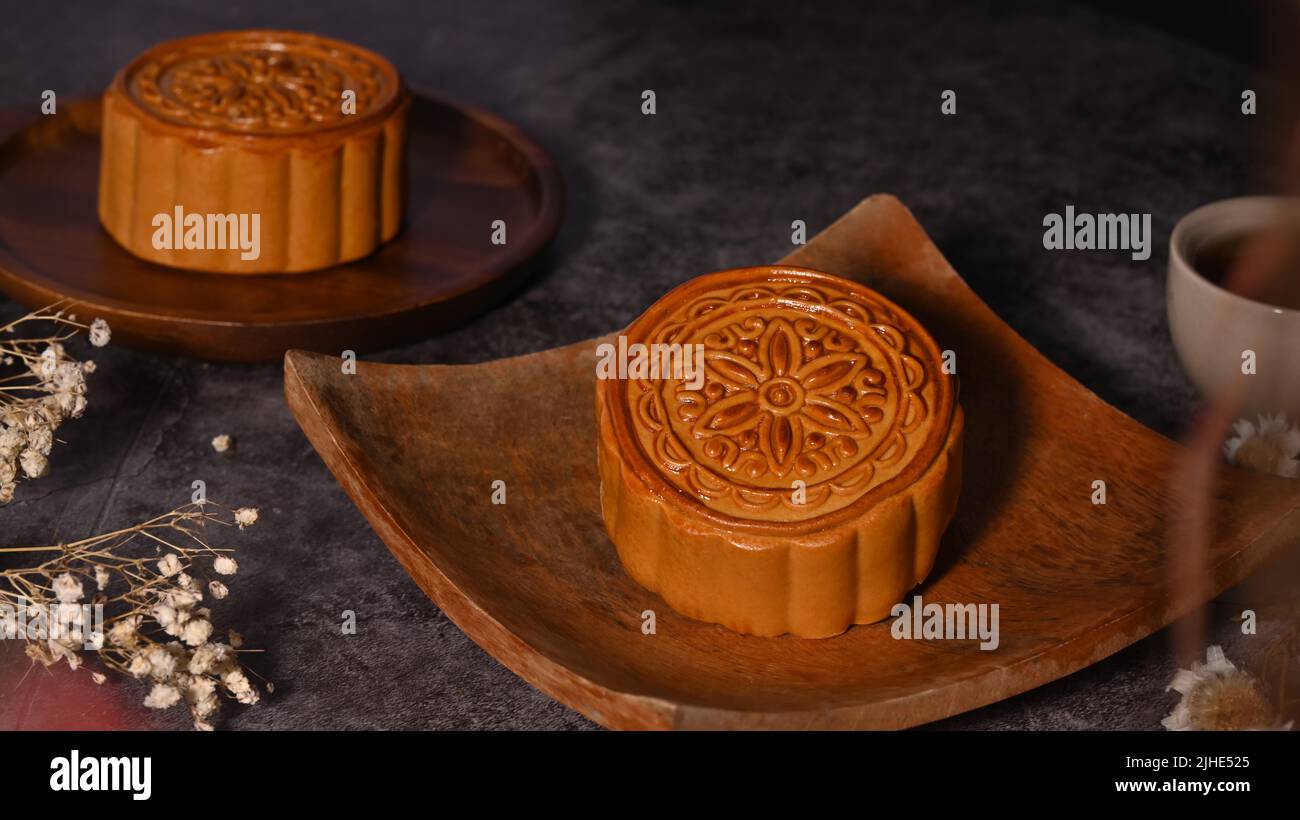 Traditional moon cakes on wooden plate. Chinese mid Autumn festival ...