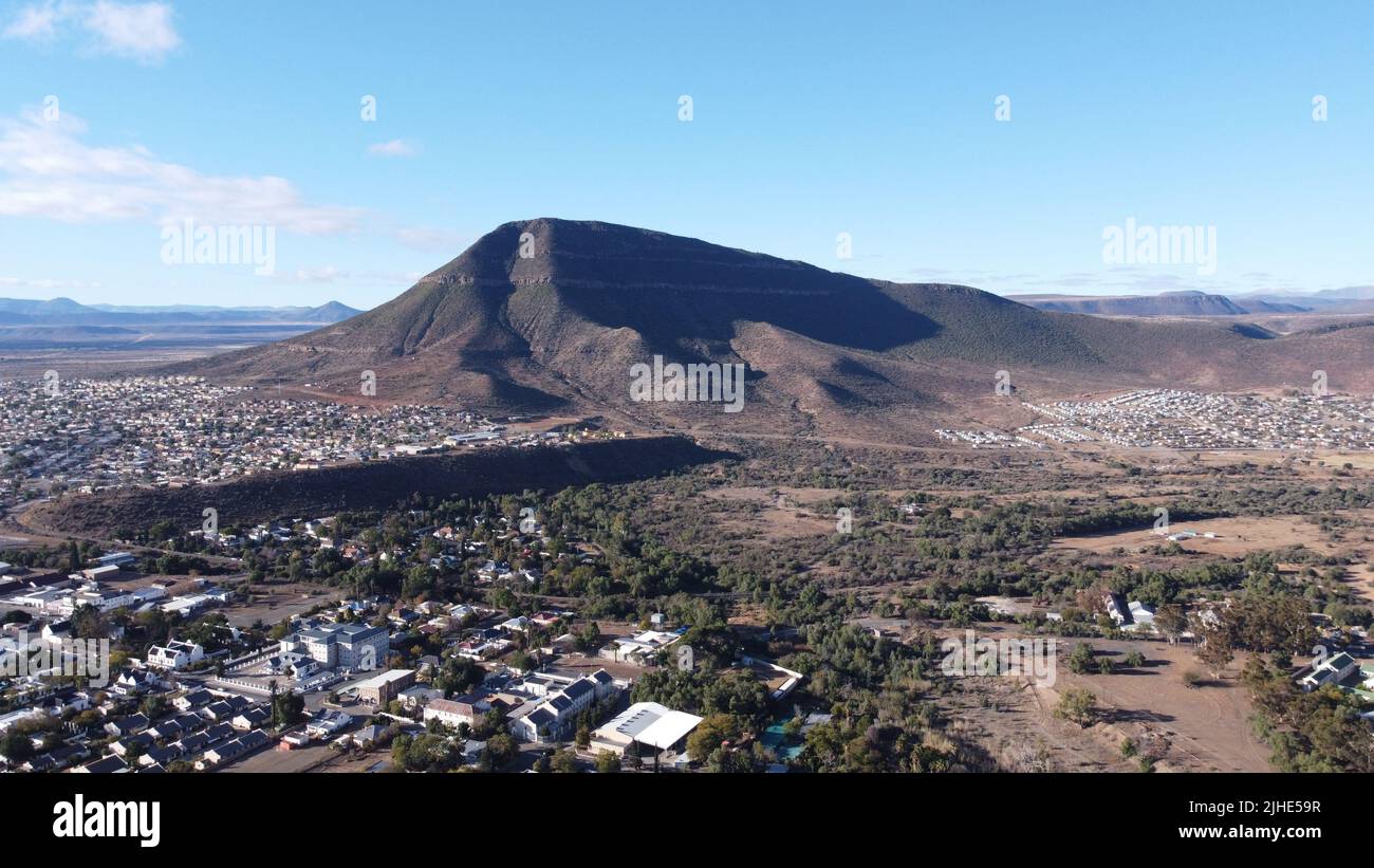 A cityscape view of city streets, desert spaces green spaces with ...