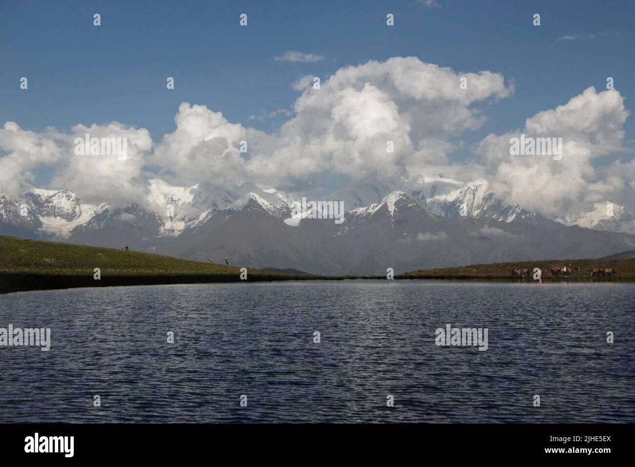 A mesmerizing scene of calm gray sea and green plains on the horizon ...