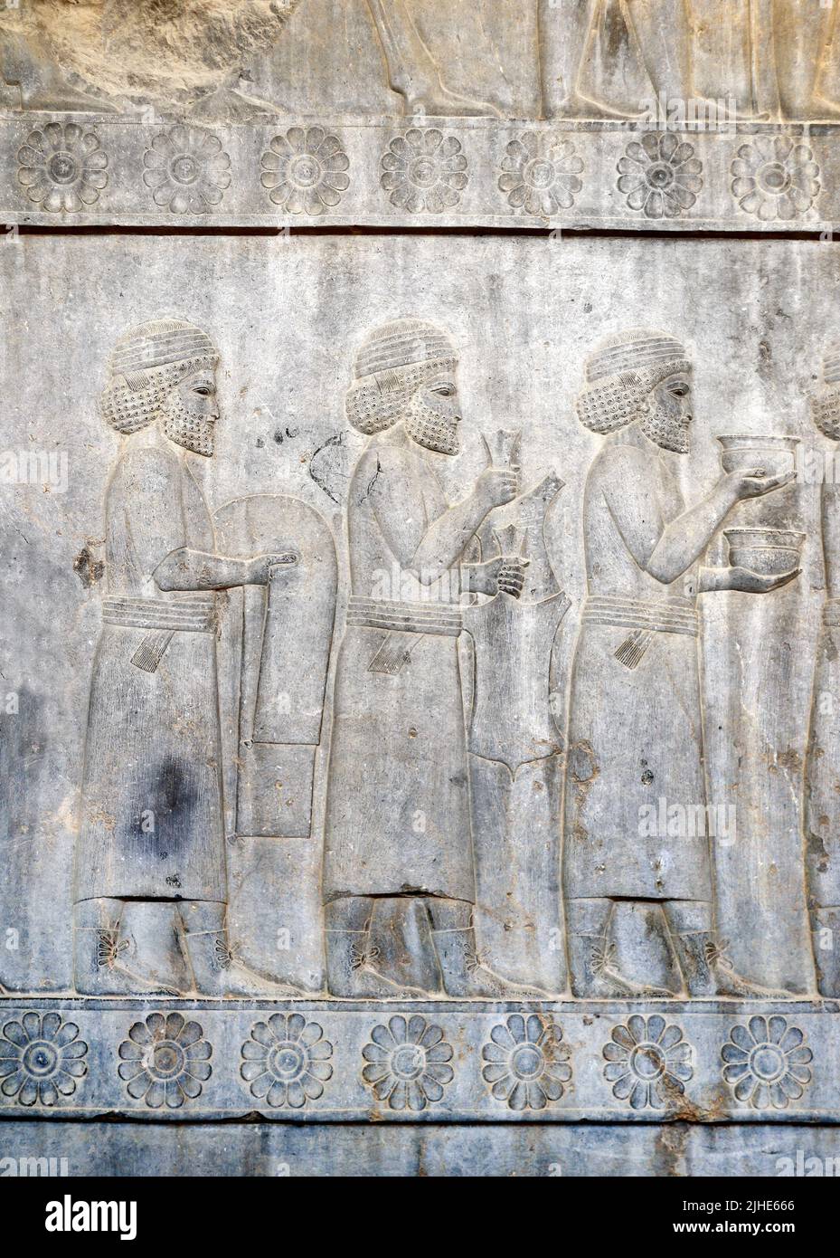 Ancient wall with bas-relief with assyrian foreign ambassadors with ...