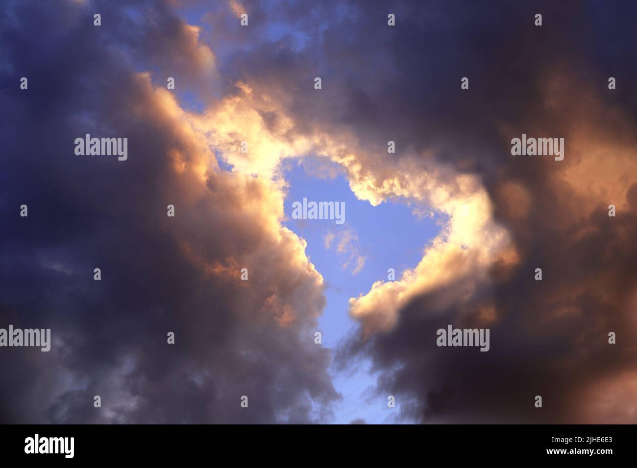 Heart in cloud. Heart shaped hole in stormy sky. Valentine background ...