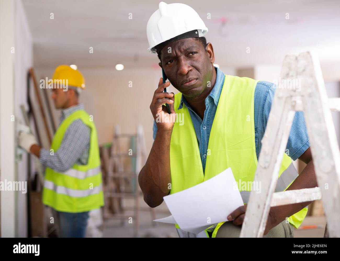 Man builder having telephone conversation in construction site Stock ...