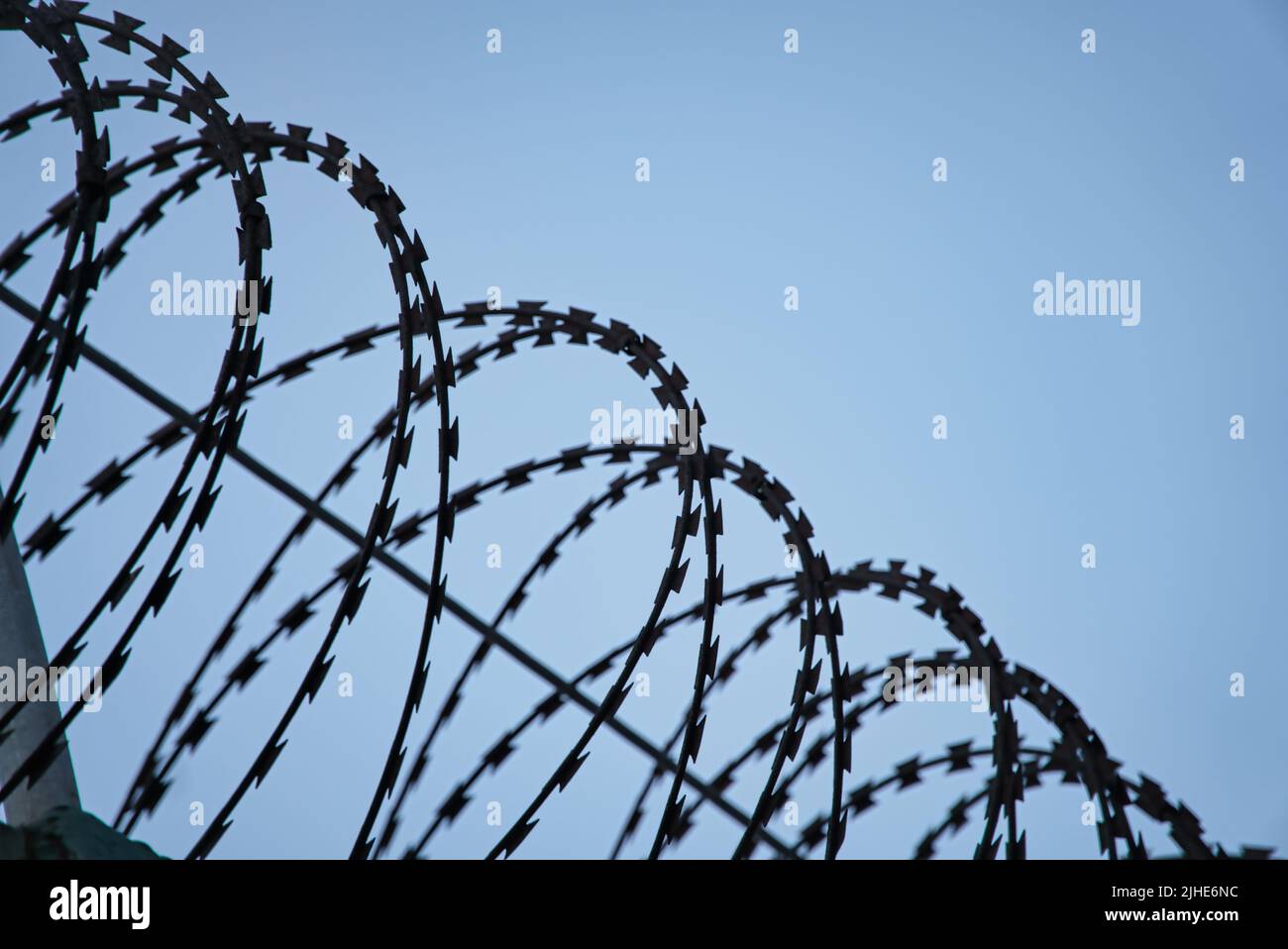 A circular metal fence against blue sky background Stock Photo - Alamy