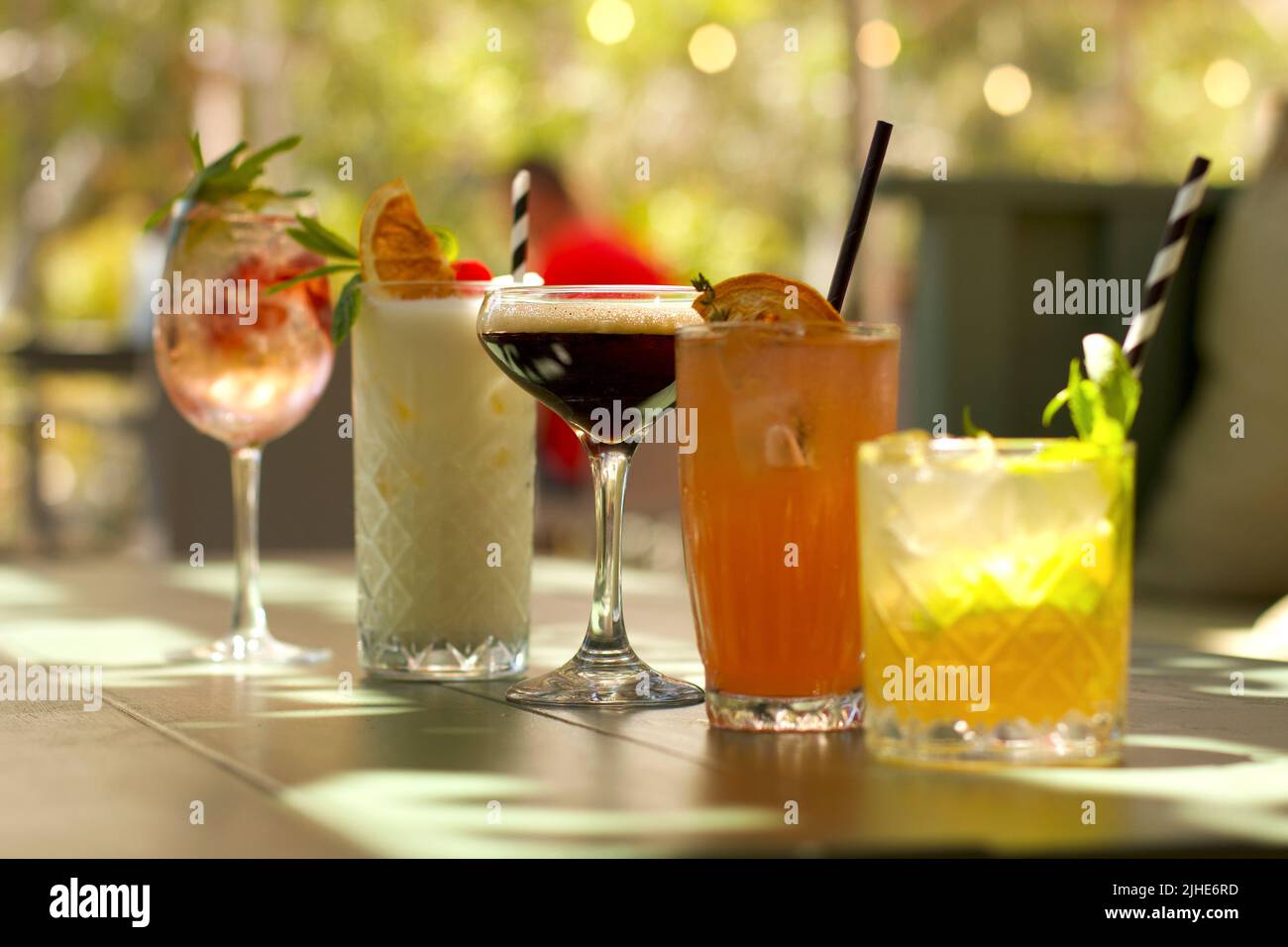 Various colorful cocktails on a table against blurry background Stock ...