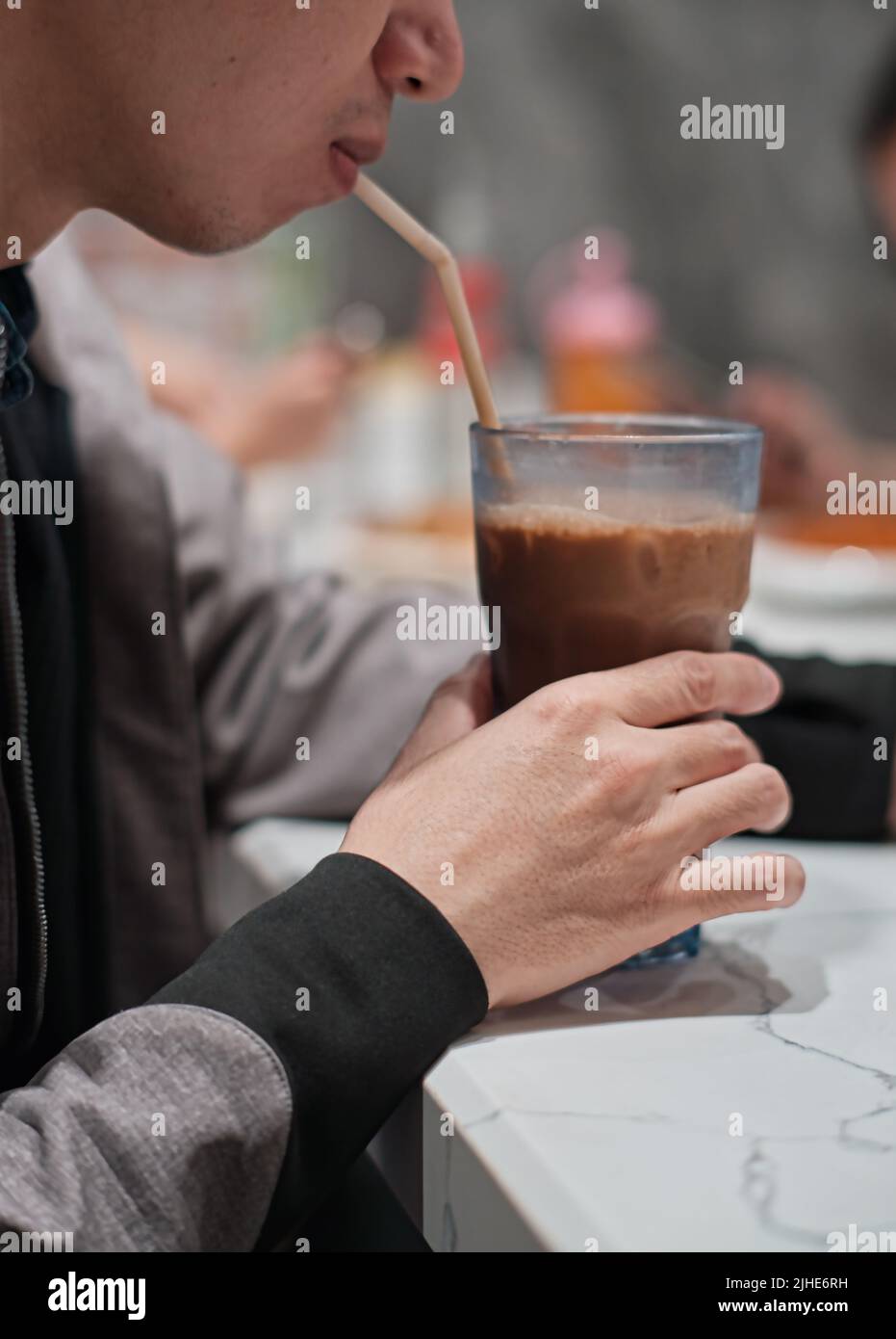 Asian man drinking coffee with straw hi-res stock photography and images - Alamy