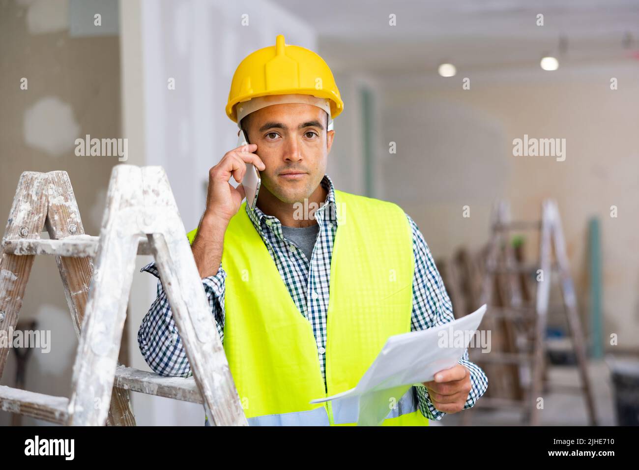 Man builder having telephone conversation in construction site Stock ...