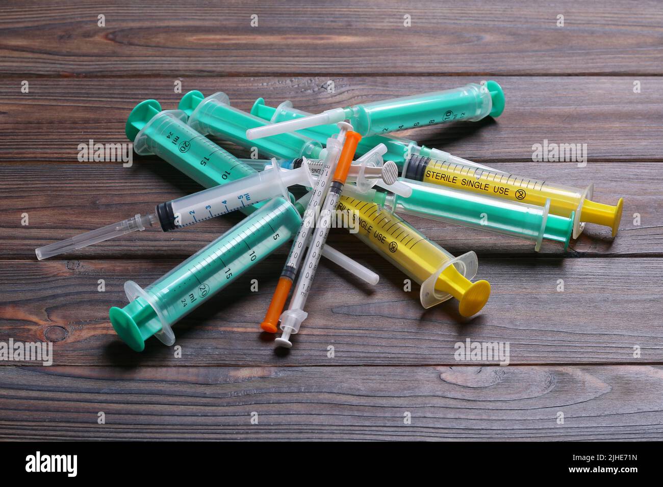 Top view of a pile of syringes and insulin syringes ready for injection ...