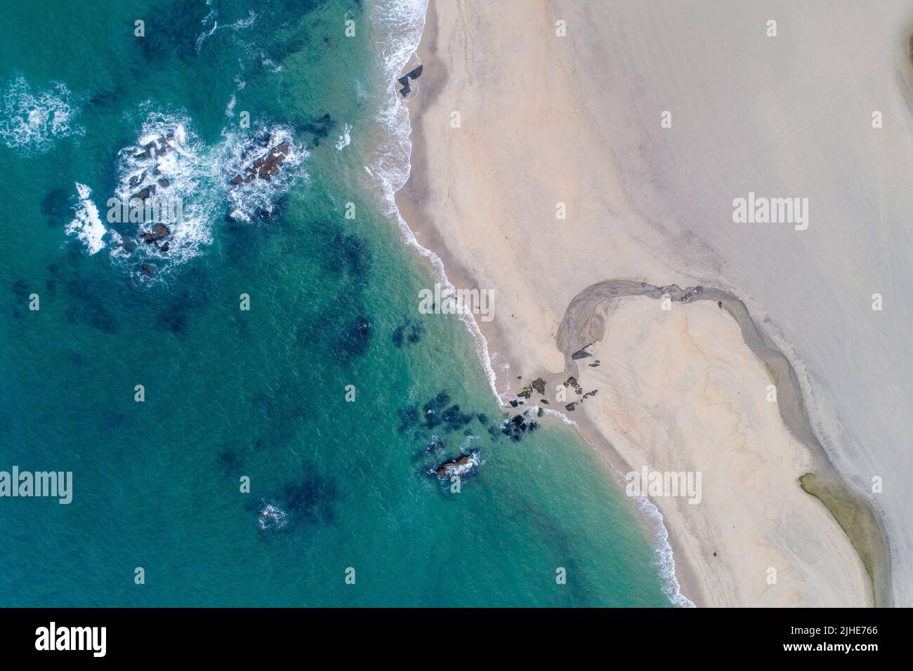 Aerial view of a beach with a small stream Stock Photo - Alamy