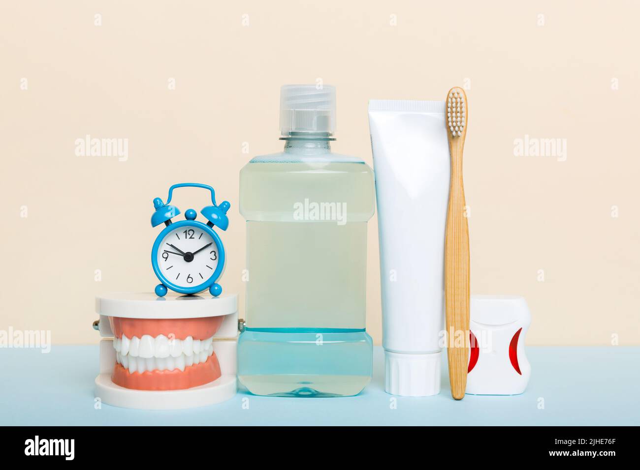 Mouthwash and other oral hygiene products on colored table top view ...