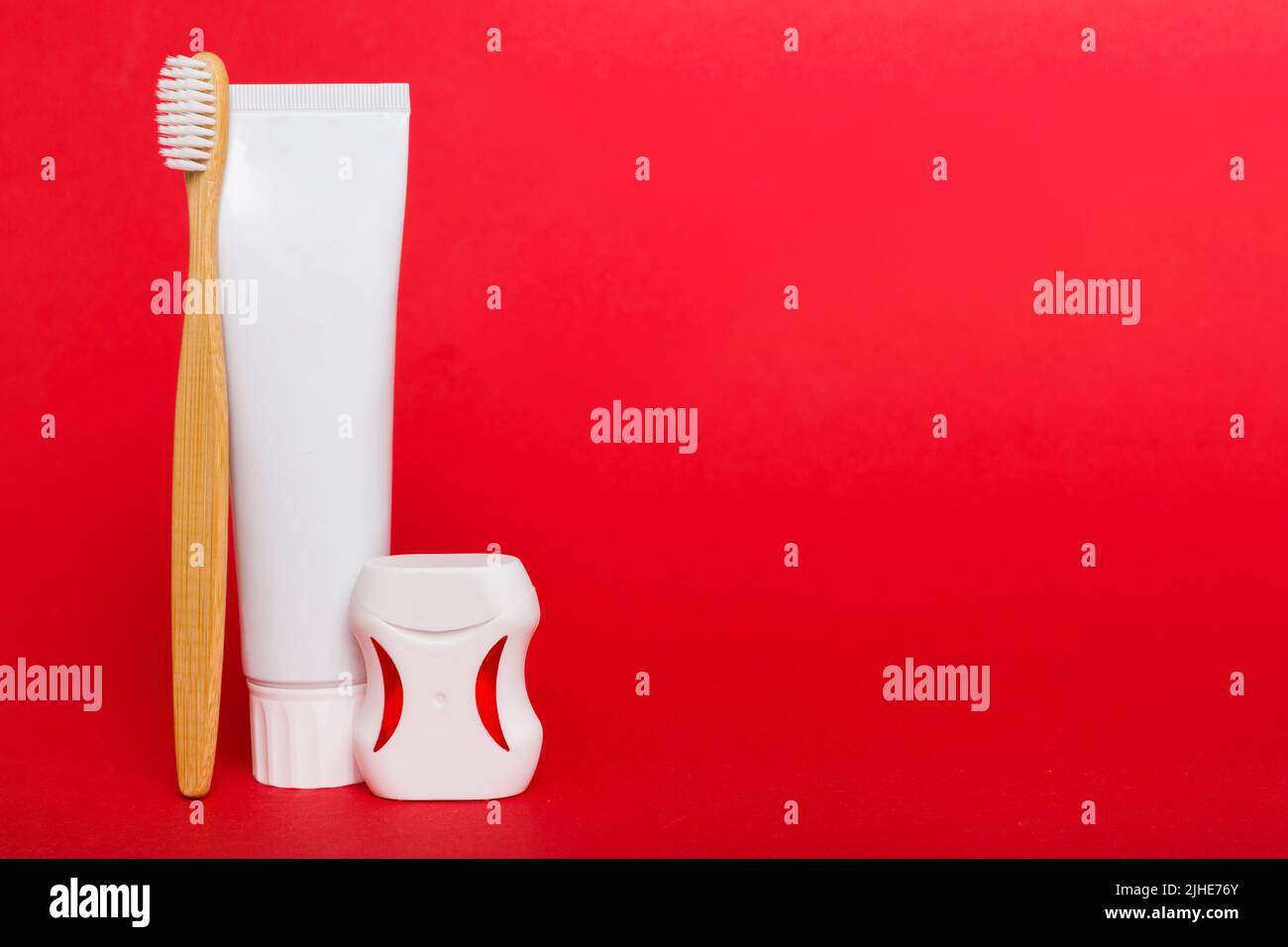 toothpaste and toothbrush top view with copy space on colored ...
