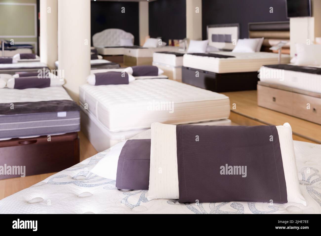 Closeup of pillows on modern comfortable orthopedic mattress on display ...