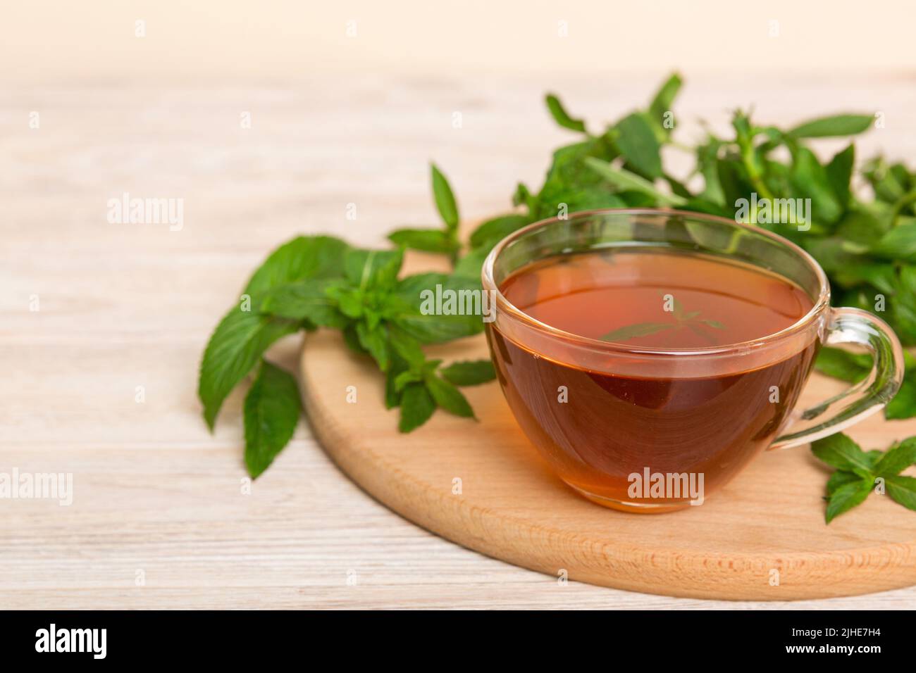 Cup of mint tea on table background. Green tea with fresh mint top view ...