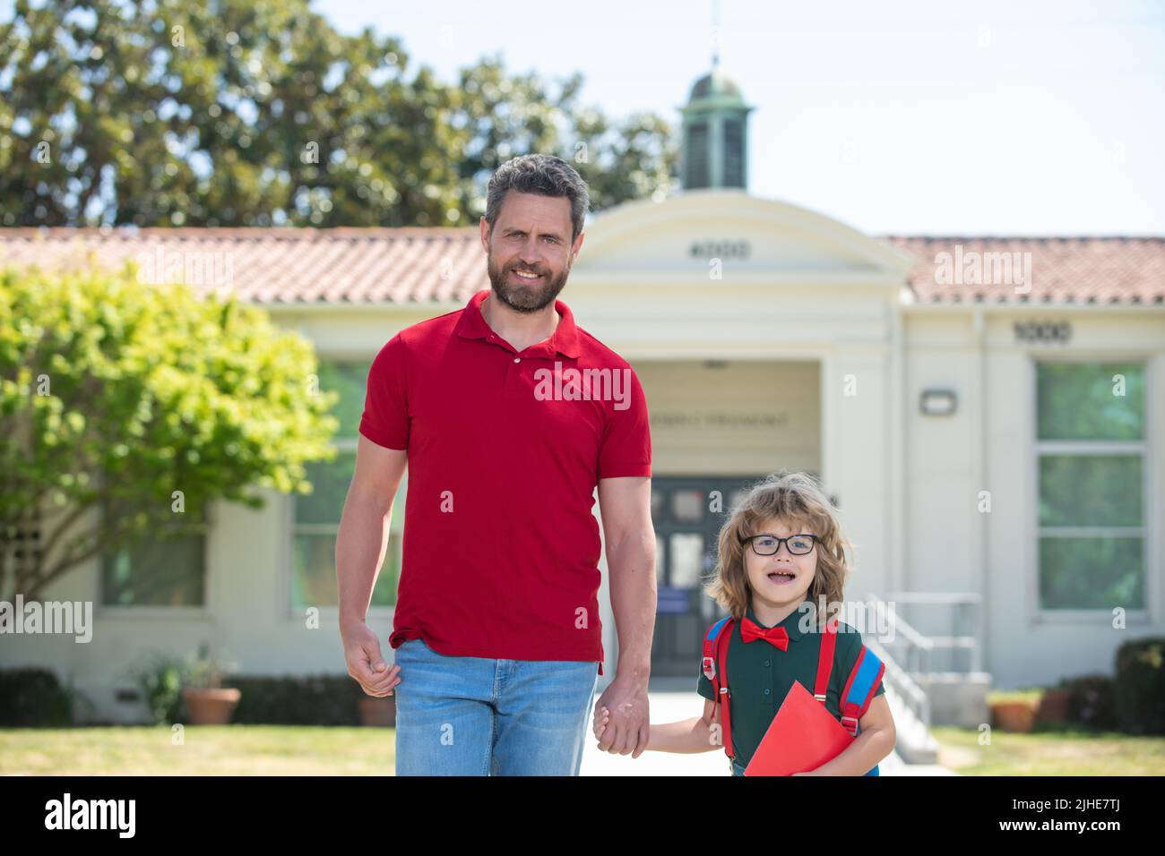 Father supports and motivates son. Kid going to primary school Stock ...