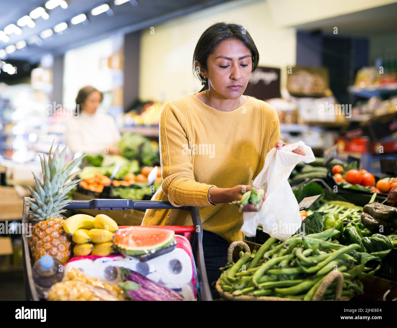 Ordinary woman buys beans at grocery supermarket Stock Photo - Alamy